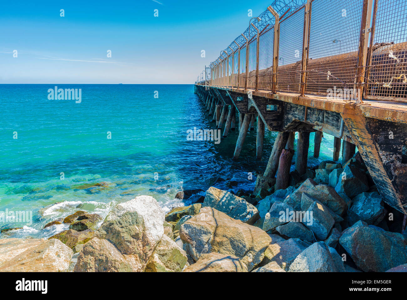 Industrial jetty protected with barbed wire to prevent passage in ...