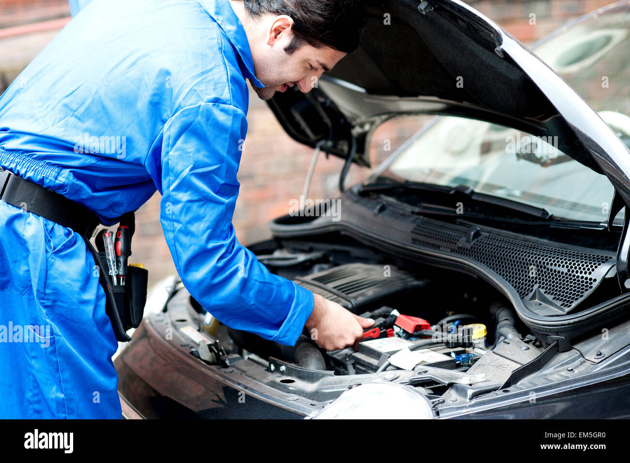 Mechanic repairing car's engine Stock Photo - Alamy