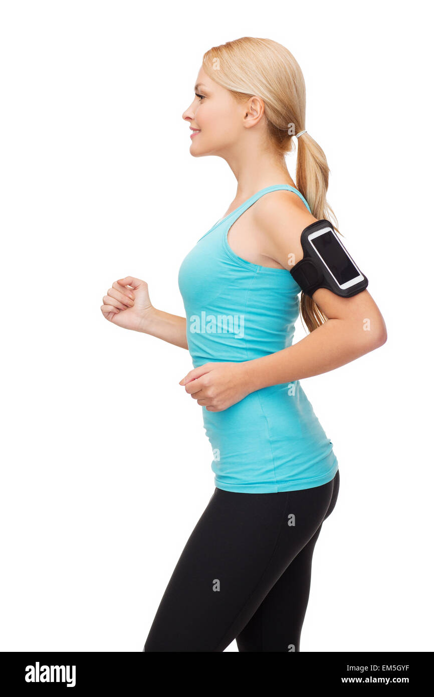 sporty woman running with smartphone Stock Photo - Alamy