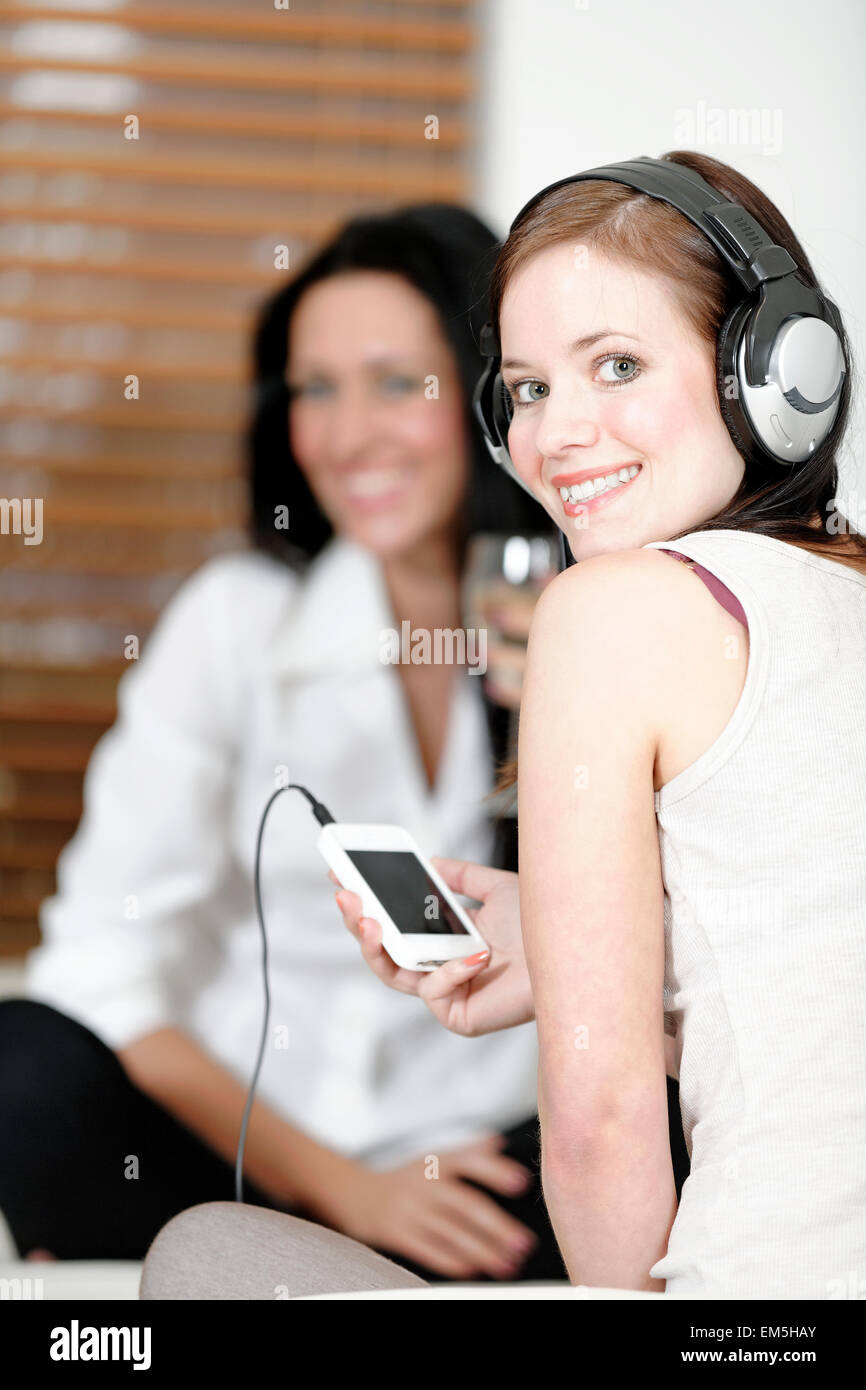 Two friends listening to music Stock Photo - Alamy