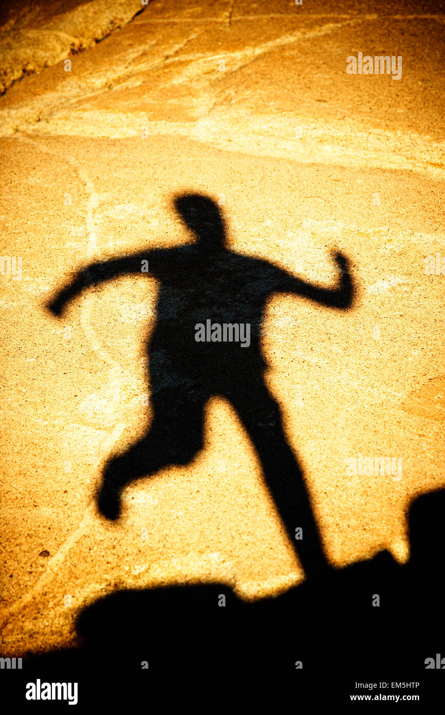 Shadow of a woman running Stock Photo - Alamy