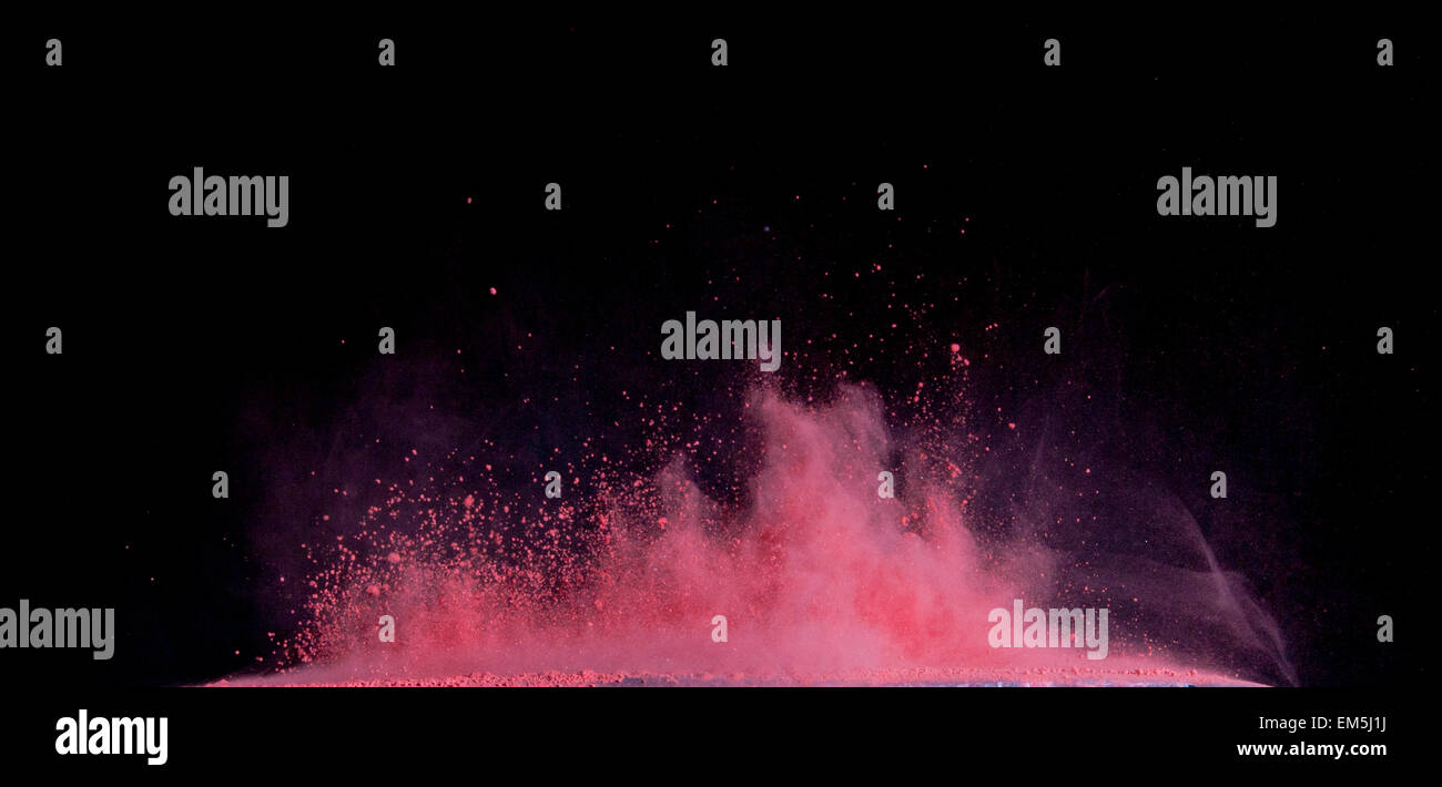 Powder paint explosion red background hi-res stock photography and ...