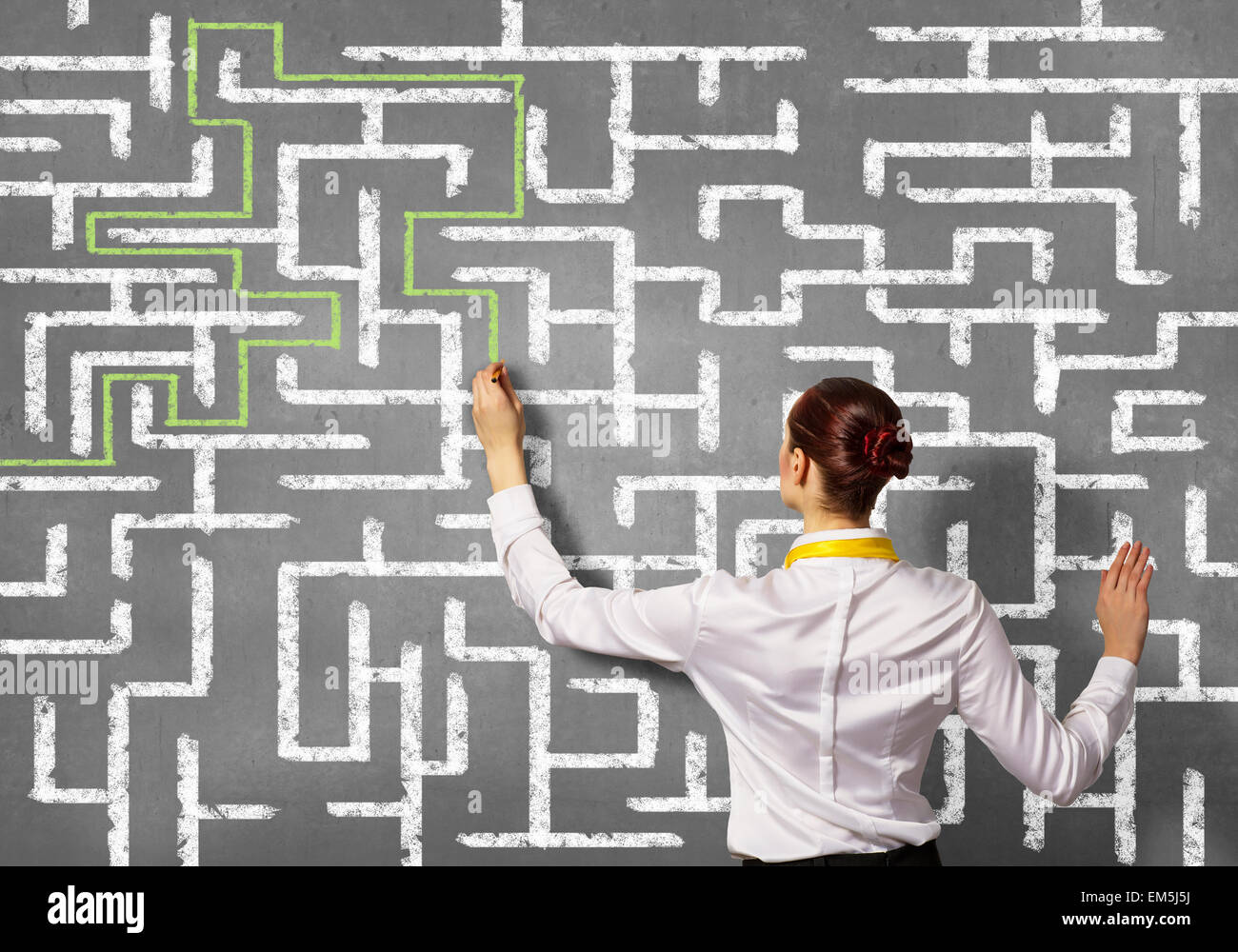 Businesswoman solving maze problem Stock Photo - Alamy