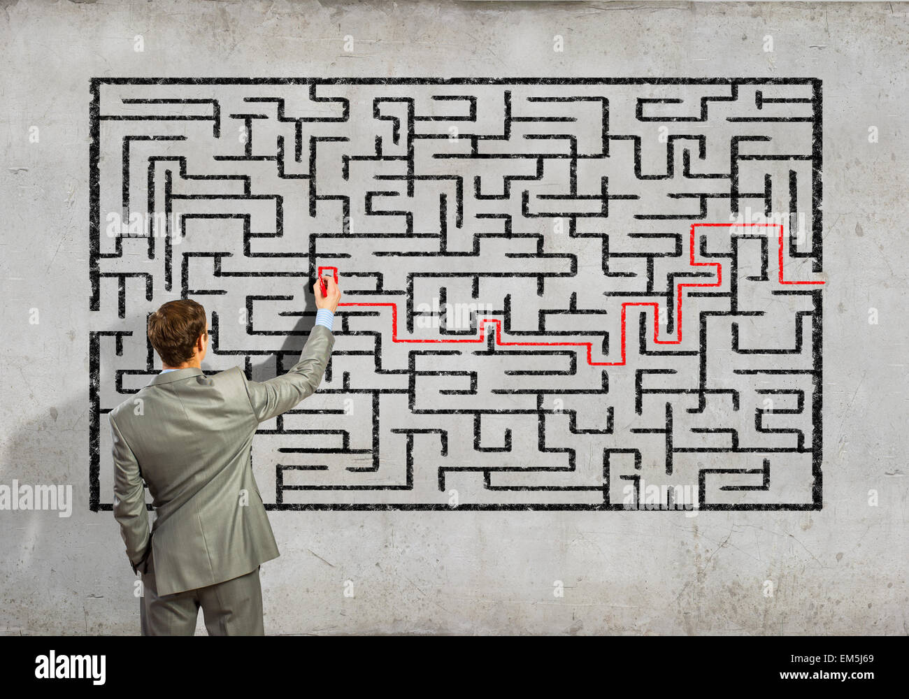 Businessman solving labyrinth problem Stock Photo - Alamy