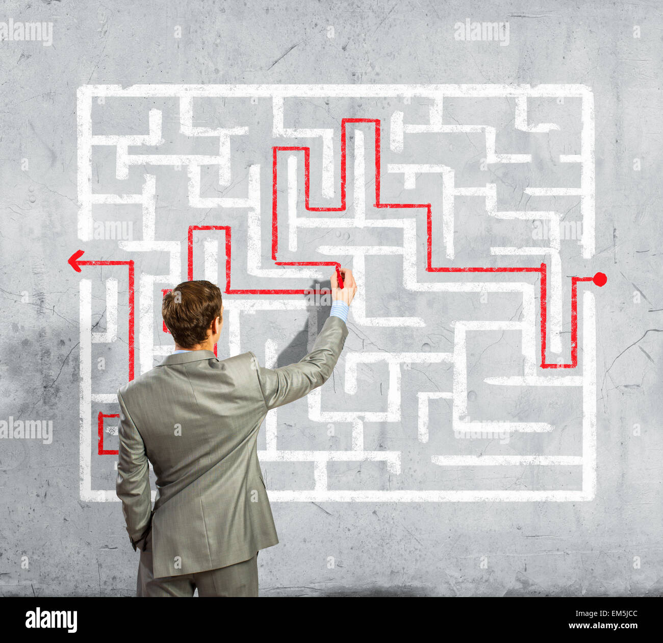 Businessman solving labyrinth problem Stock Photo - Alamy