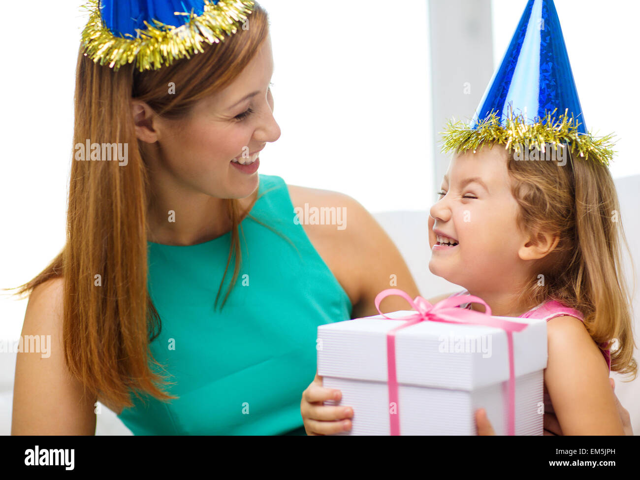 mother and daughter in blue hats with favor horns Stock Photo - Alamy