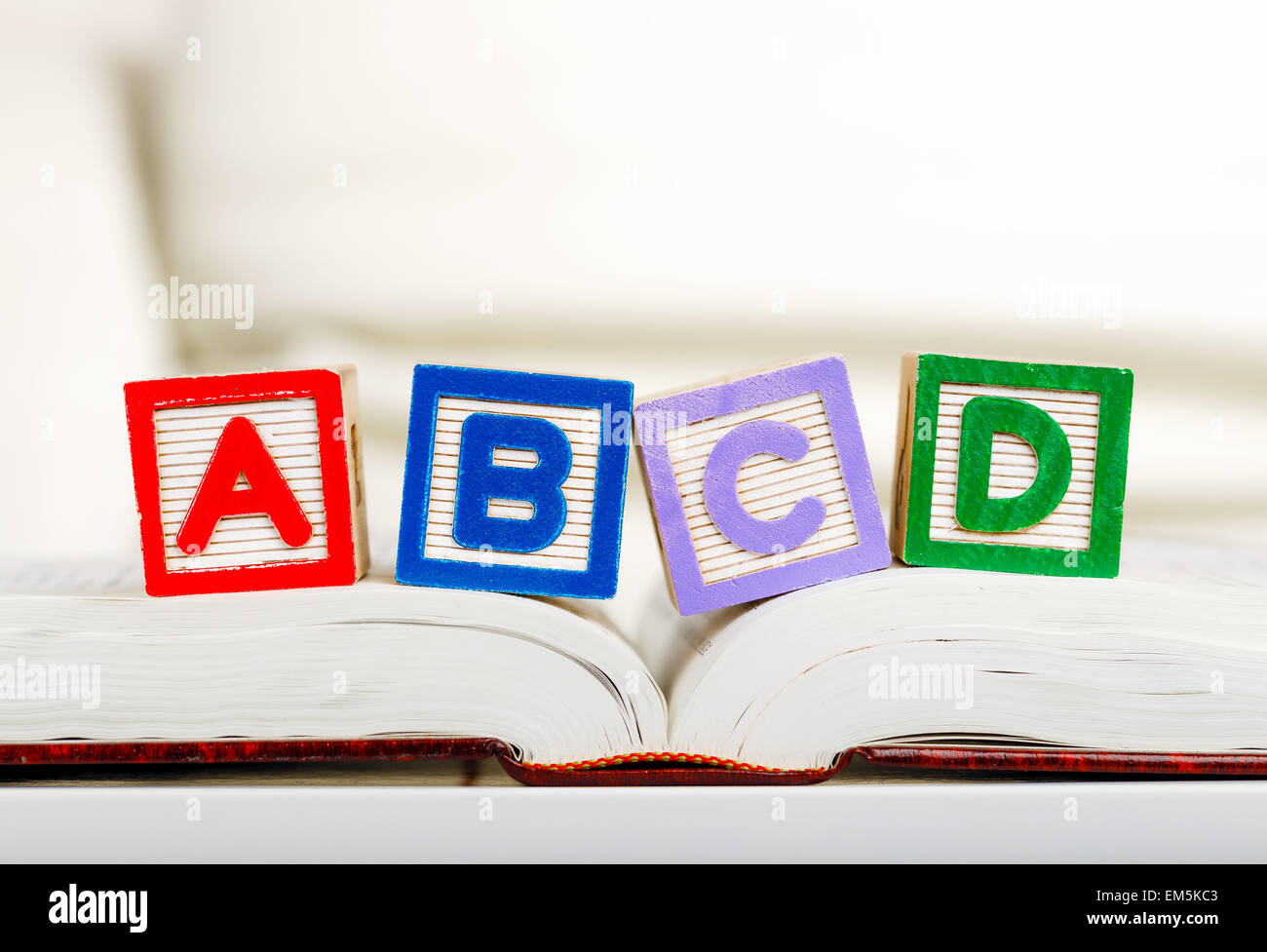 Alphabet block with ABCD on book Stock Photo - Alamy