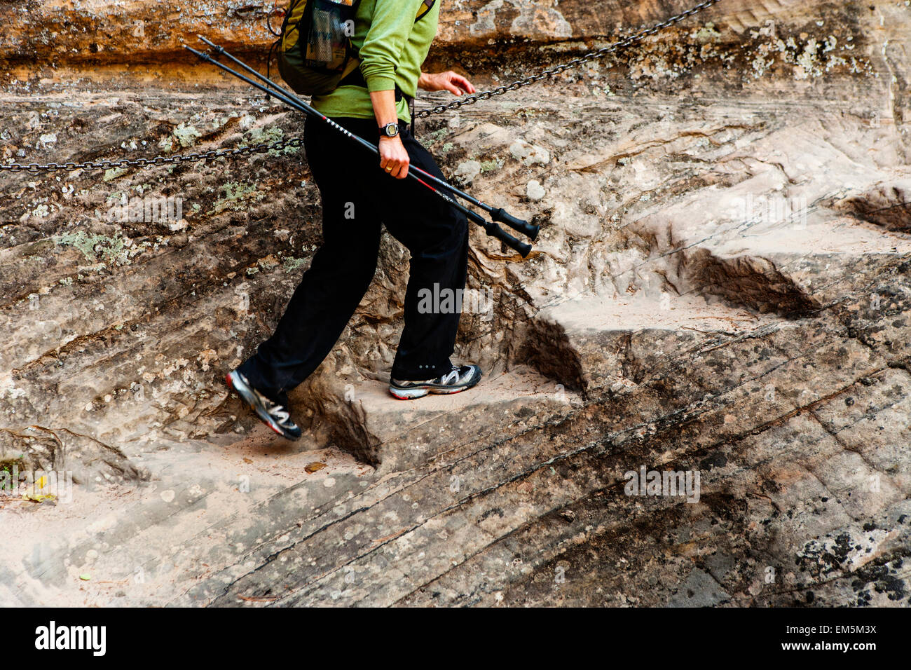 A female hiker walking up steps chopped in the side of a cliff Stock ...