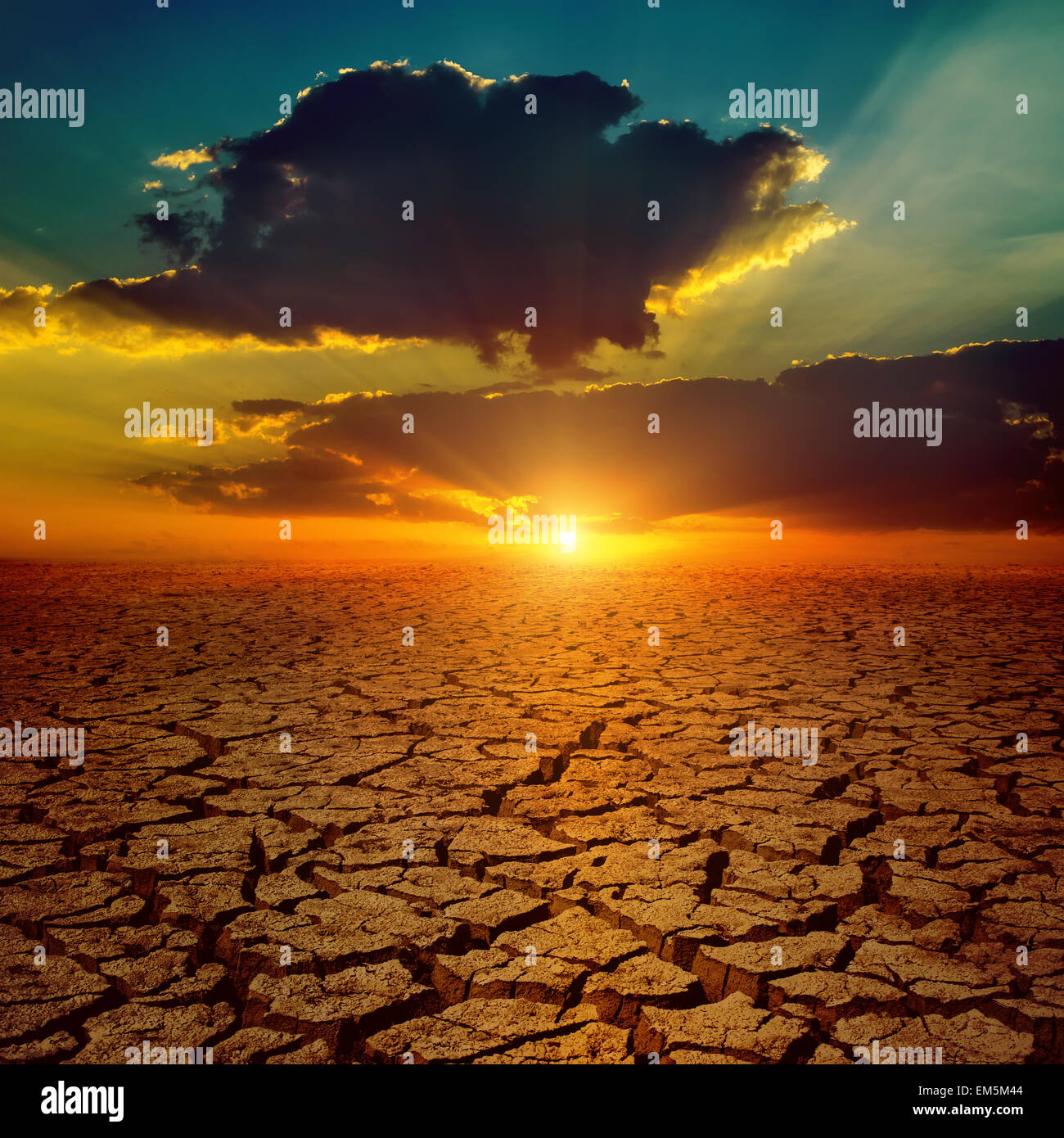 dramatic sunset over drought earth Stock Photo - Alamy