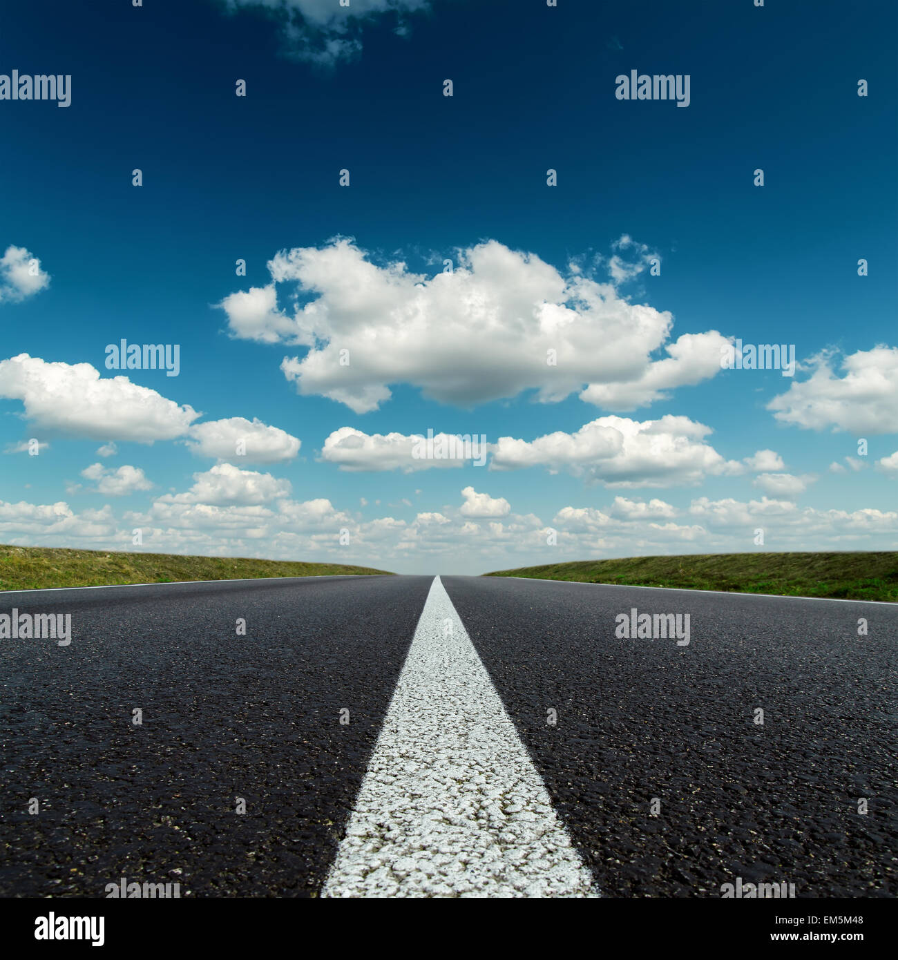 asphalt road to horizon in deep blue cloudy sky Stock Photo - Alamy
