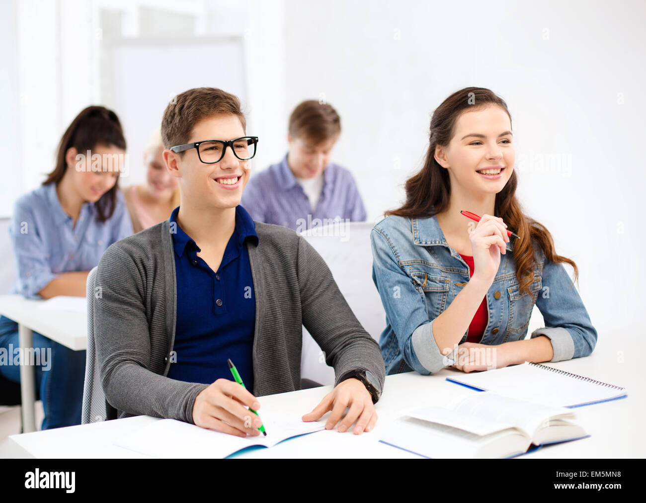 smiling students with notebooks at school Stock Photo - Alamy