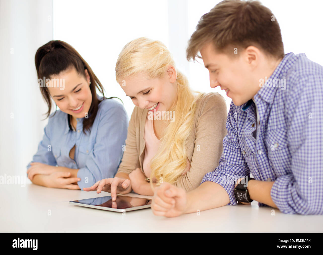 smiling students with tablet pc computer at school Stock Photo - Alamy