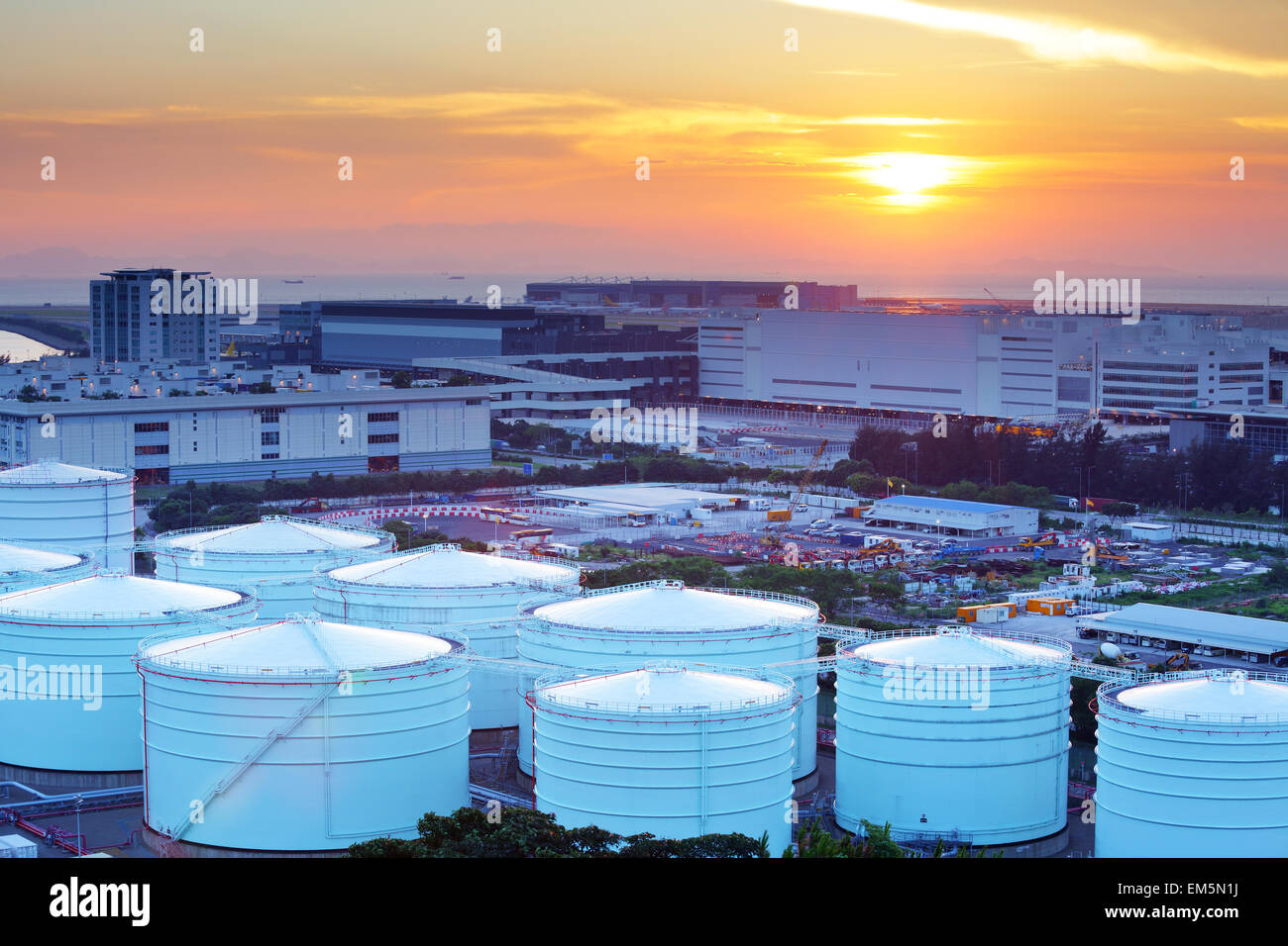 Oil tanks for cargo service during sunset Stock Photo - Alamy