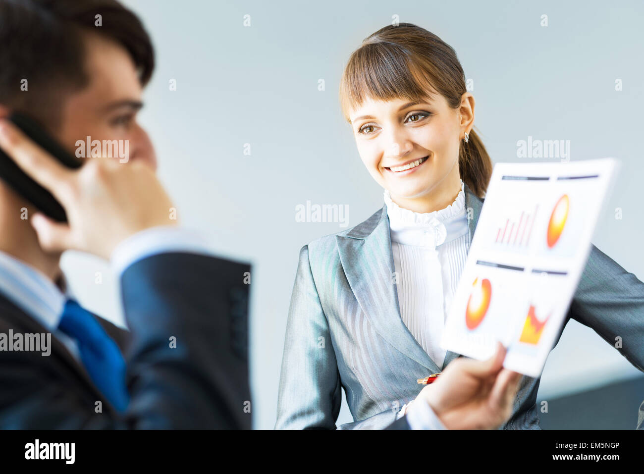 two business partners discussing reports Stock Photo - Alamy