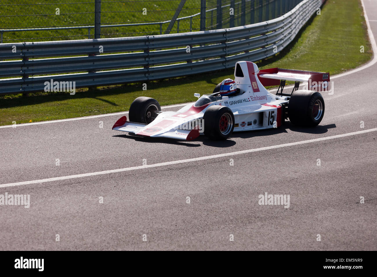 A classic Embassy-Hill Formula One race car enters the pit lane at ...