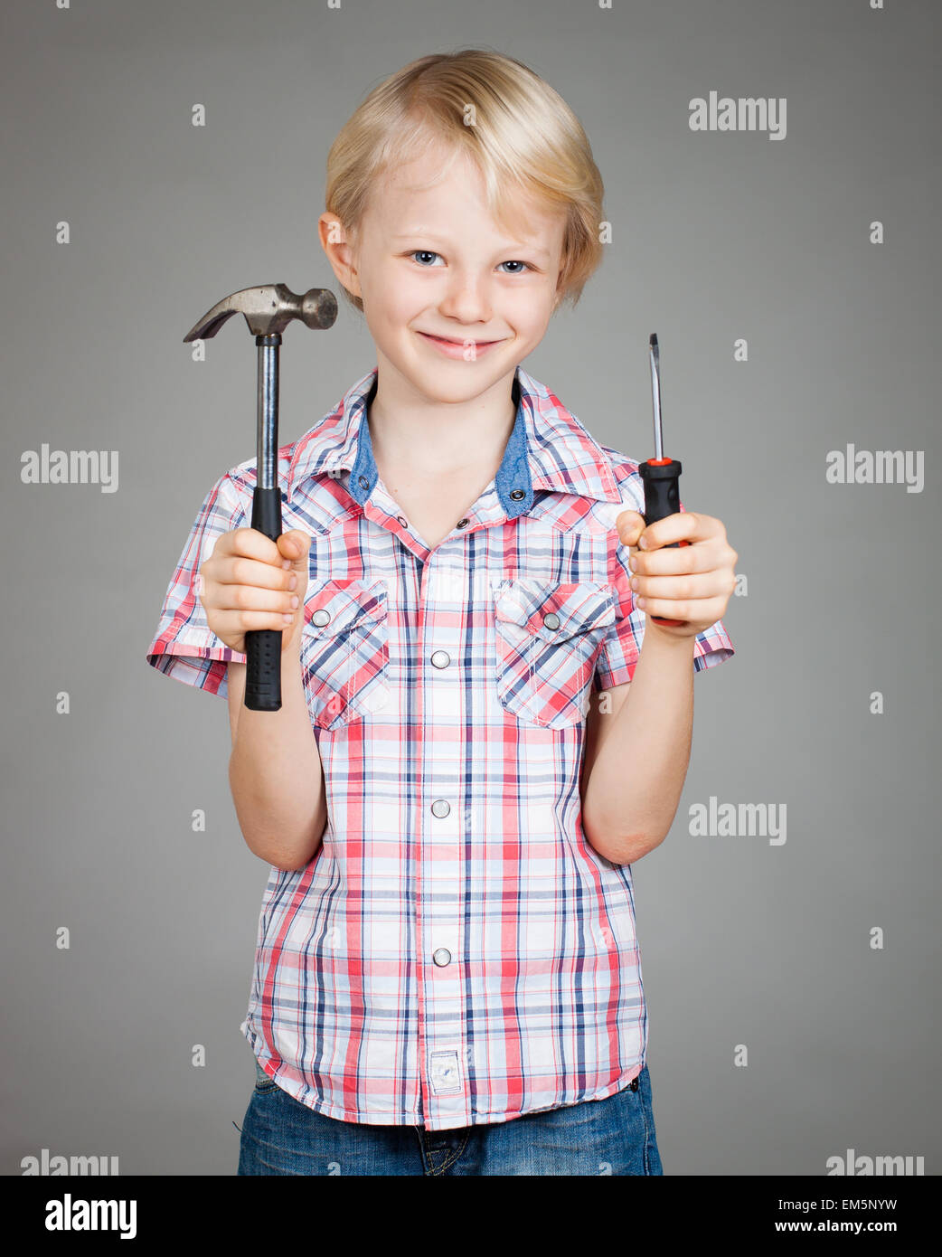 Cute boy hammer and screwdriver Stock Photo - Alamy
