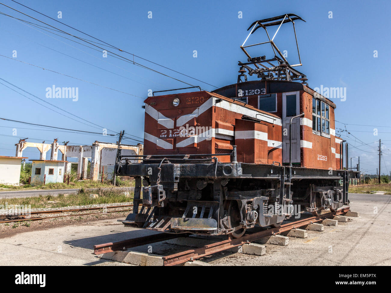 Restored train on a rusty iron rail track display plinth in a remote ...