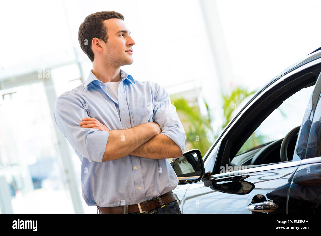 man standing near a car Stock Photo - Alamy