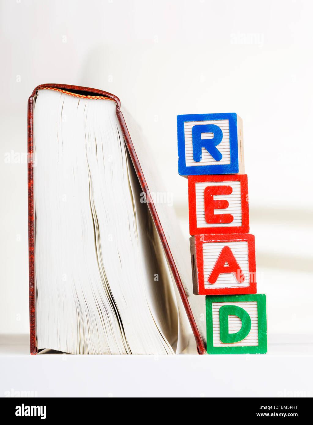 Read alphabet Block besides book Stock Photo - Alamy