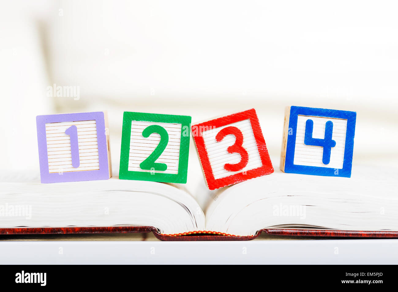 Alphabet block with 1234 on opened book Stock Photo - Alamy