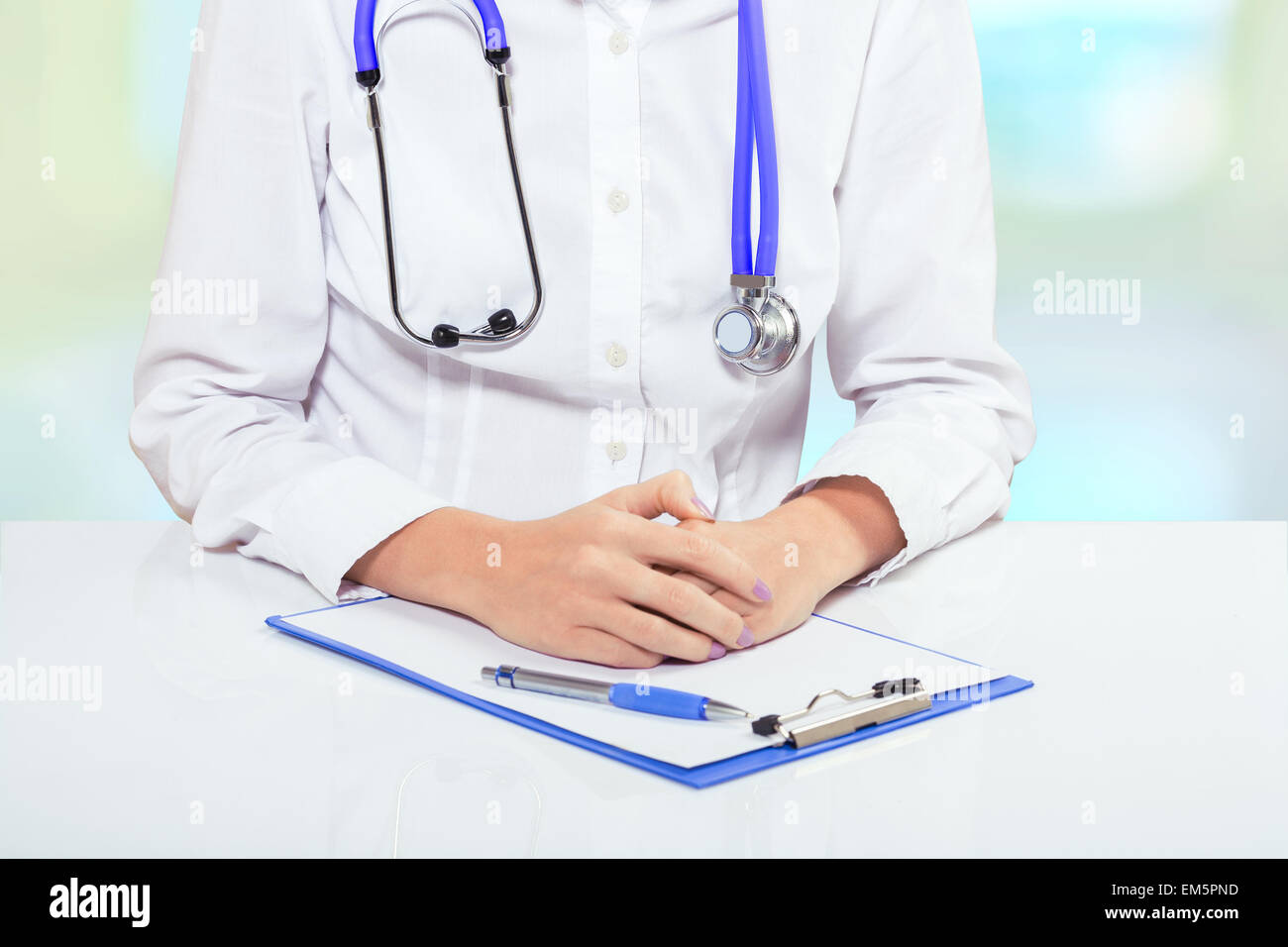 a doctor at the table with clipboard very closeup Stock Photo - Alamy