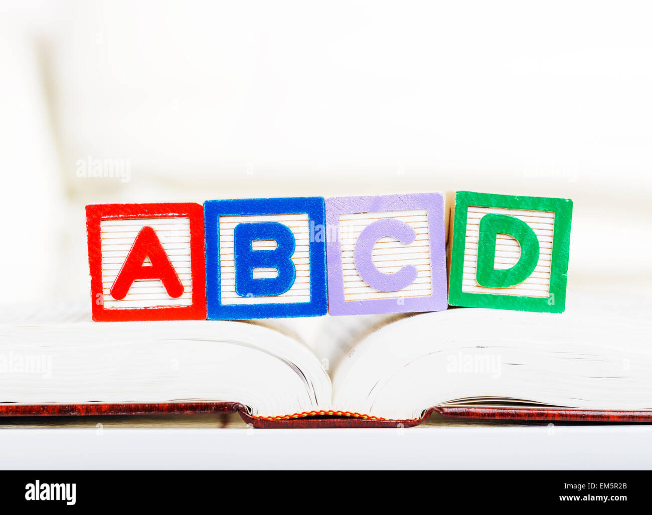 Alphabet block with ABCD on book Stock Photo - Alamy