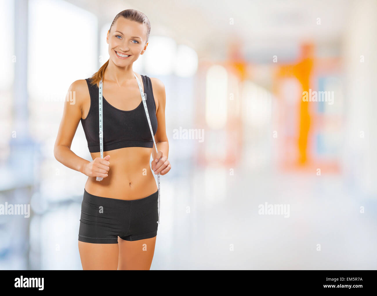 a sports girl with measure tape Stock Photo - Alamy