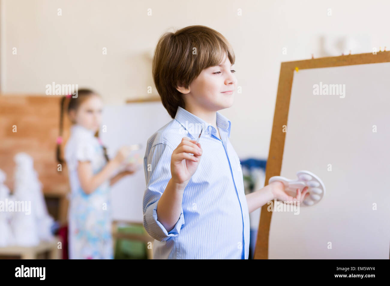Cute boy painting Stock Photo - Alamy