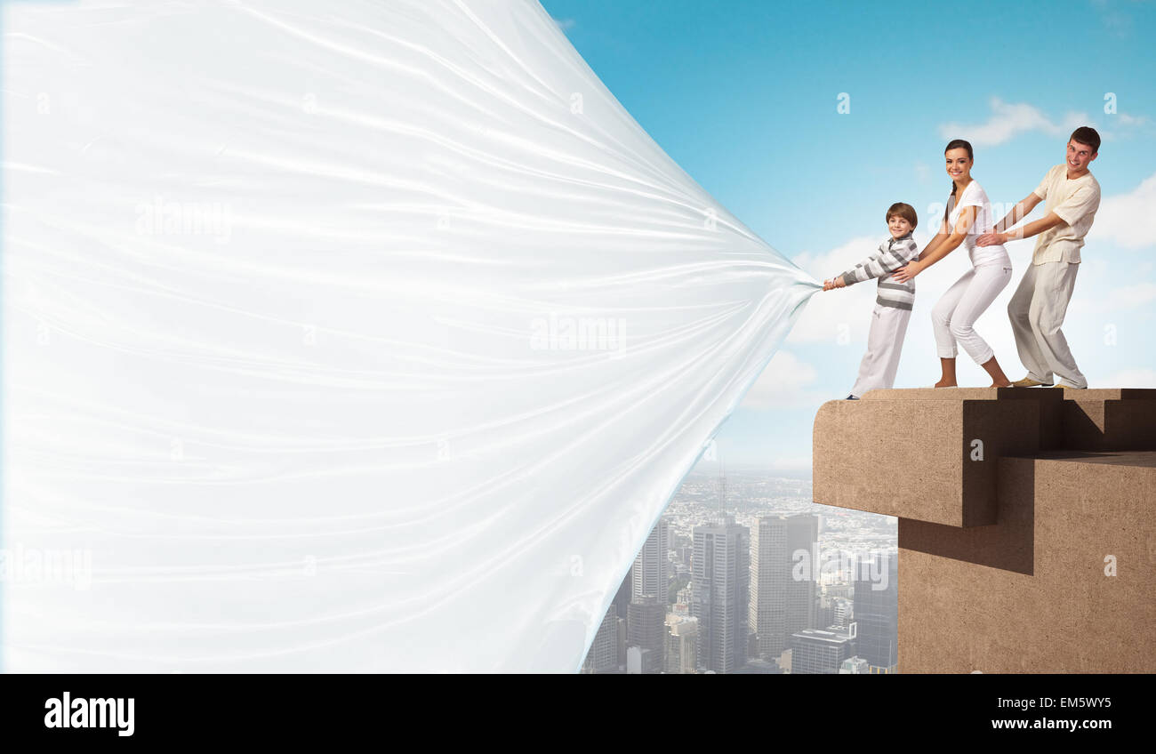 Young family pulling banner Stock Photo - Alamy