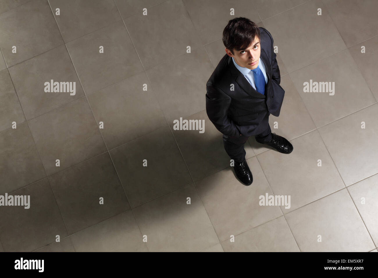 Young businessman looking above Stock Photo - Alamy