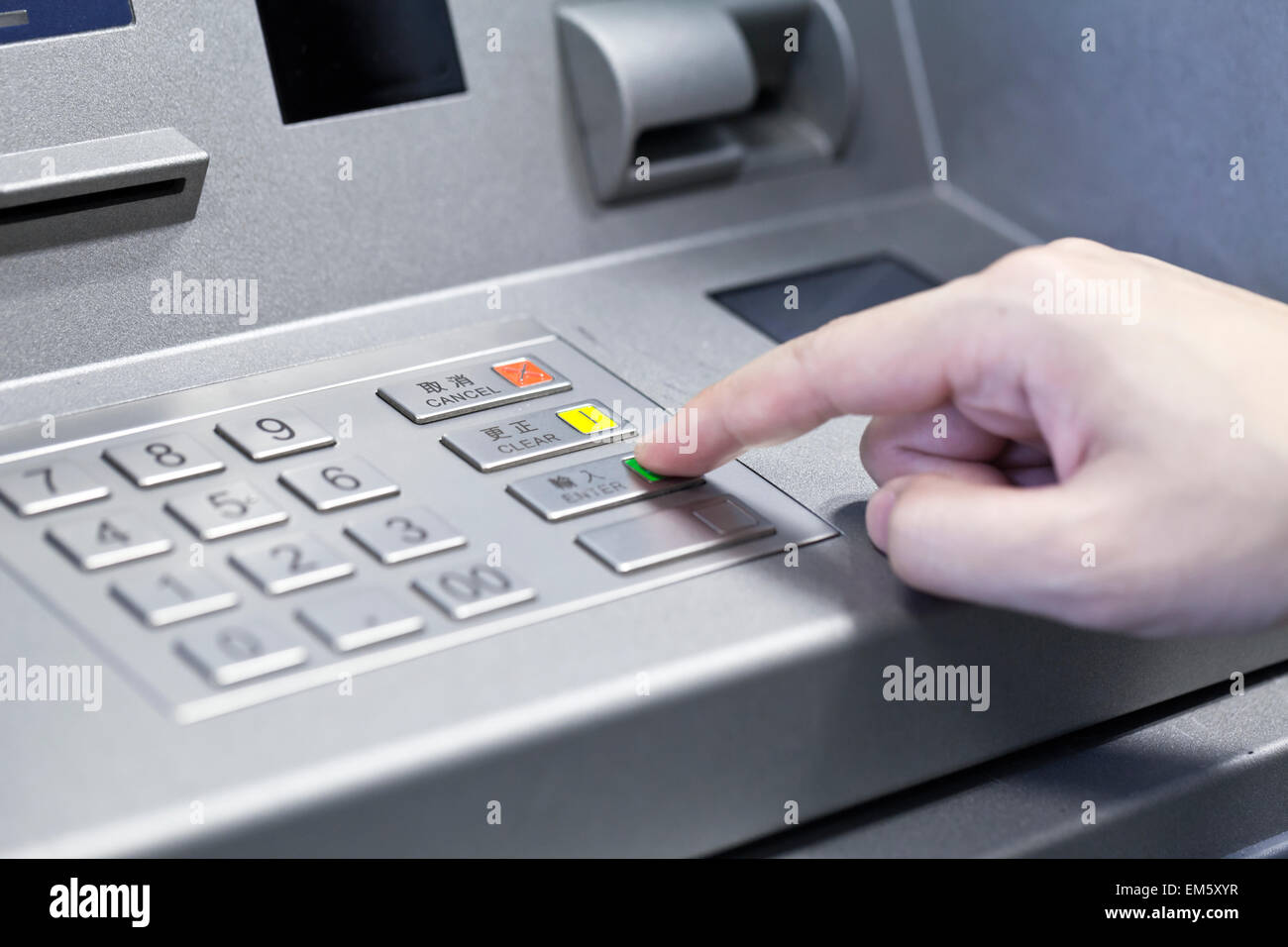 Human hand touching ATM machine Stock Photo - Alamy