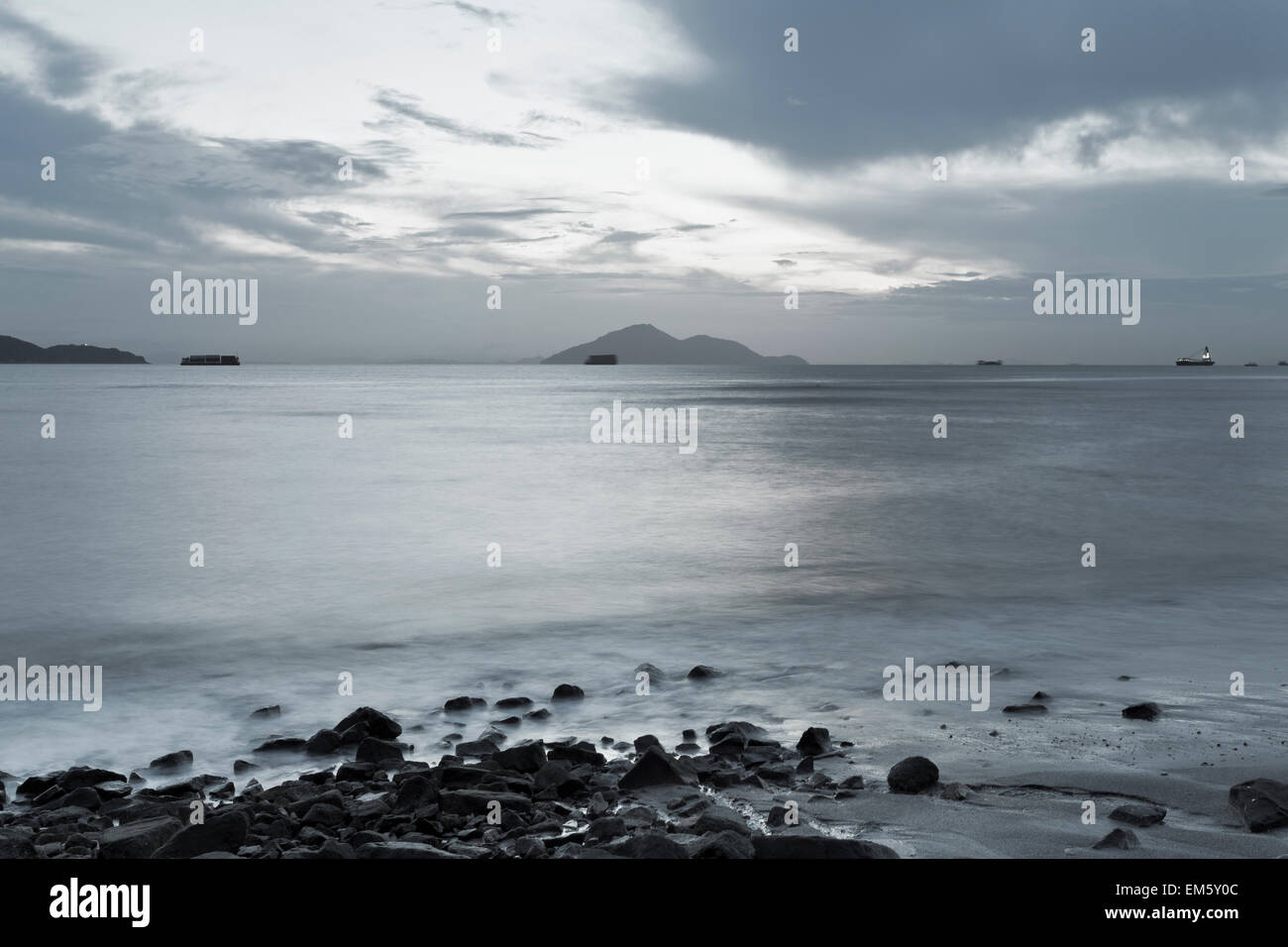 Sunset at clam sea with low saturation Stock Photo - Alamy