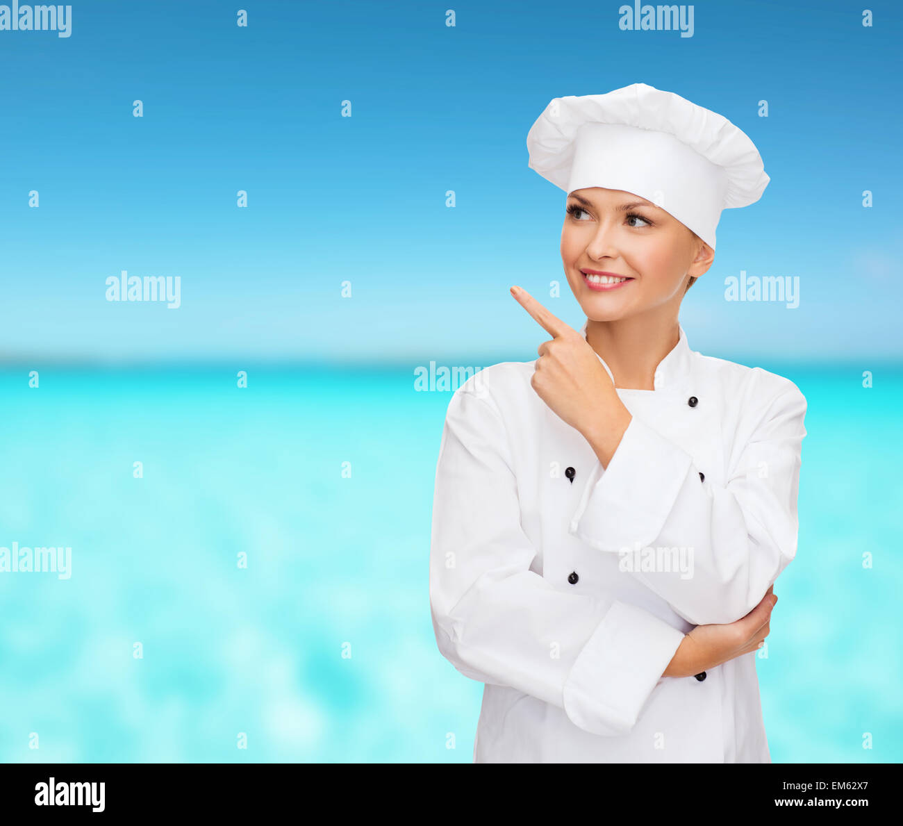 smiling female chef pointing finger to sonething Stock Photo - Alamy
