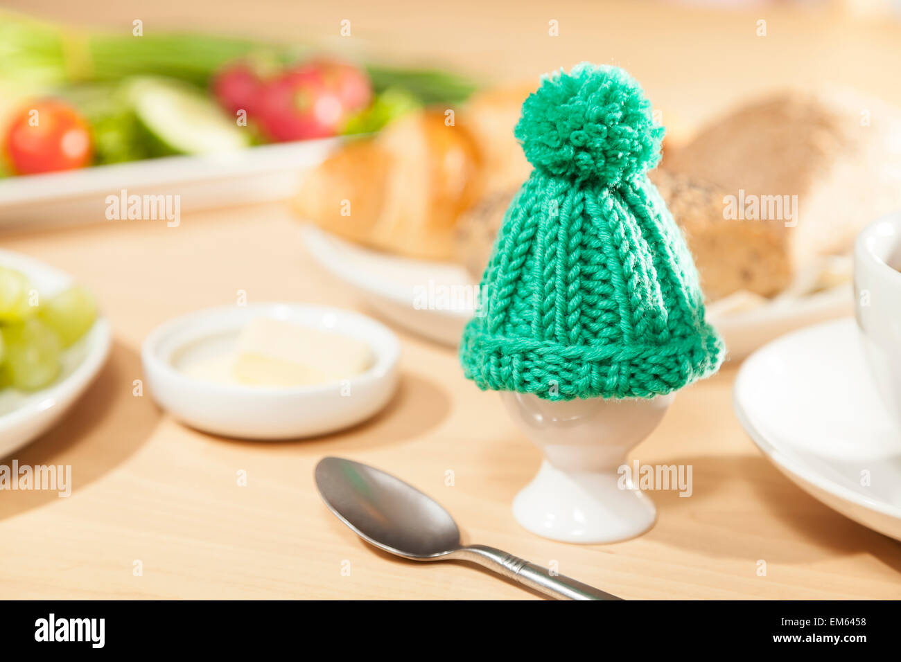 Egg cosy on breakfast table Stock Photo - Alamy