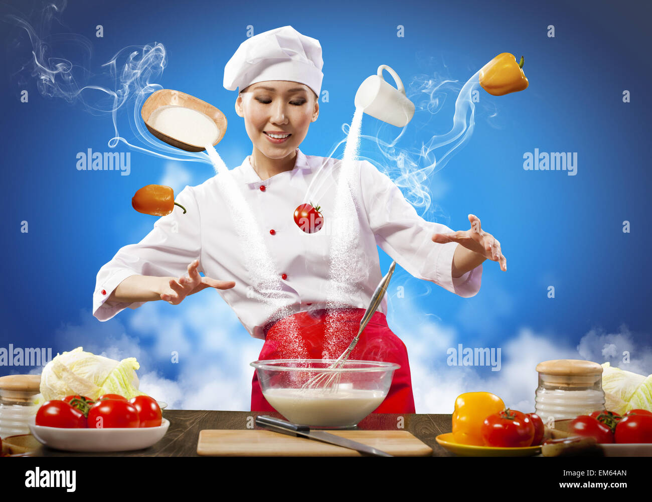 Asian female cooking with magic Stock Photo - Alamy