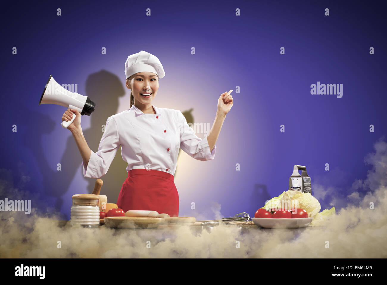 Asian female cook holding megaphone Stock Photo - Alamy
