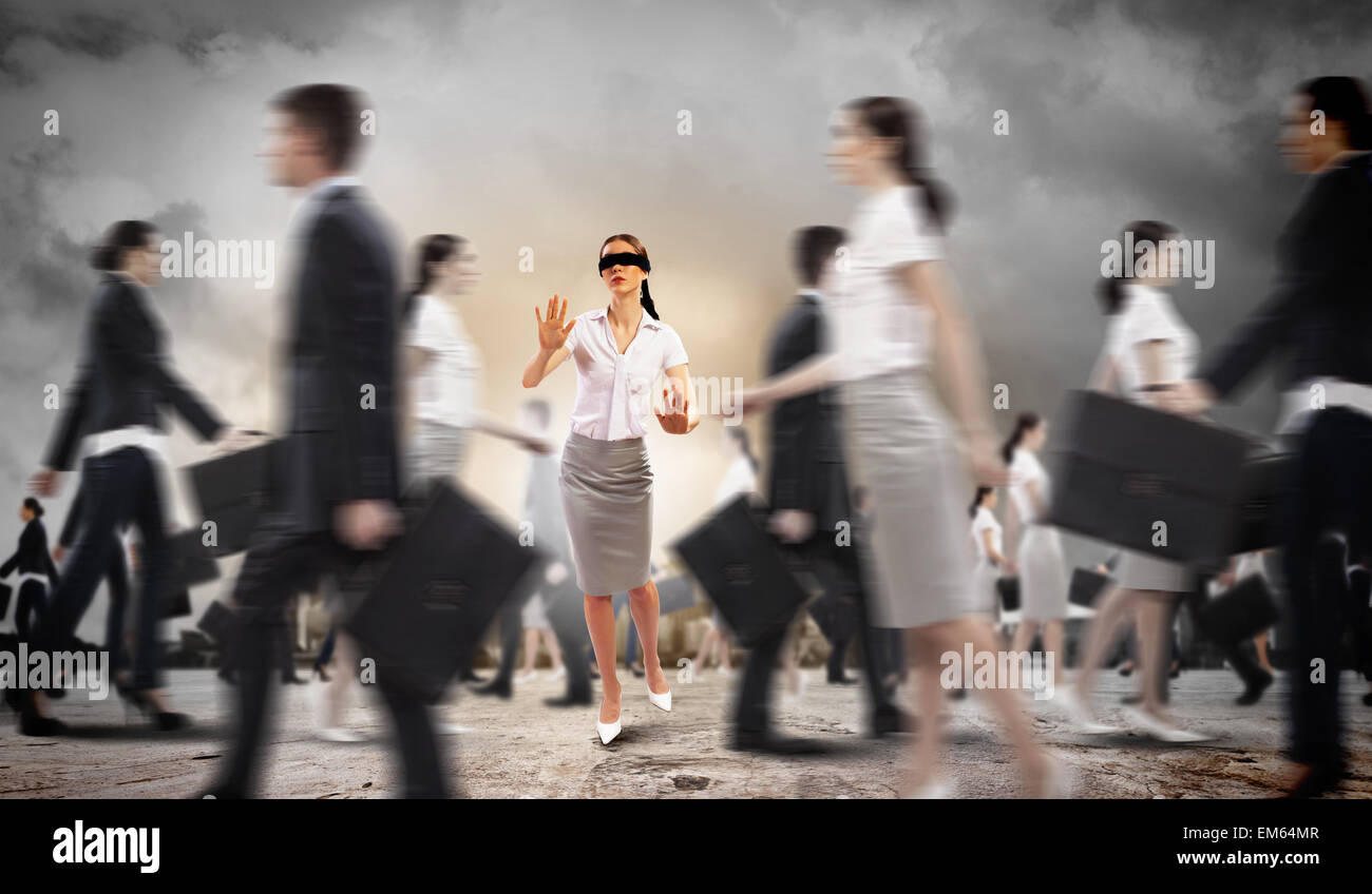 Businesswoman in blindfold among group of people Stock Photo - Alamy