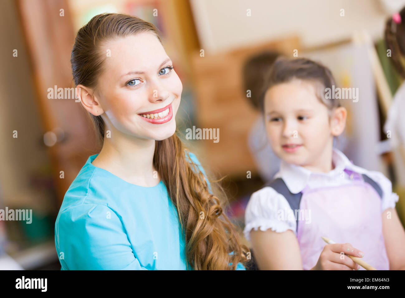 Cute girl and teacher Stock Photo - Alamy