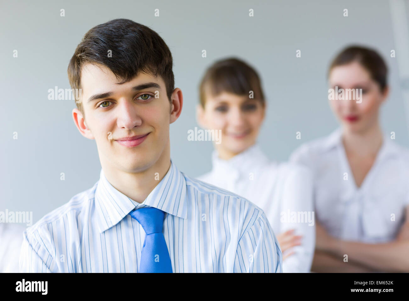Young smiling businessman Stock Photo - Alamy