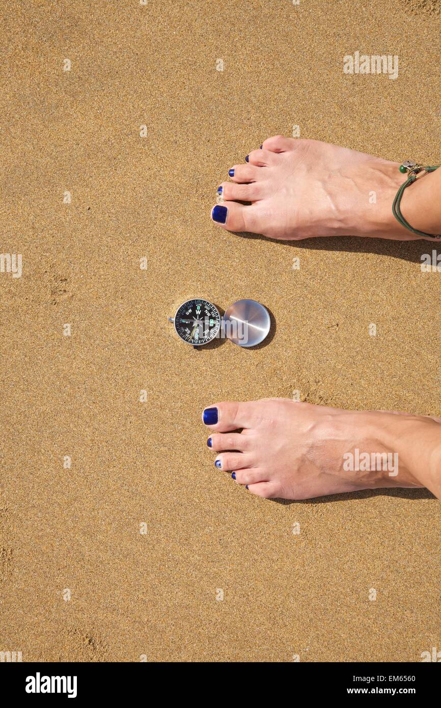 woman feet with silver compass Stock Photo - Alamy