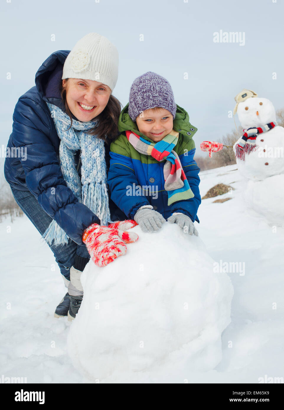Family make a snowman Stock Photo - Alamy