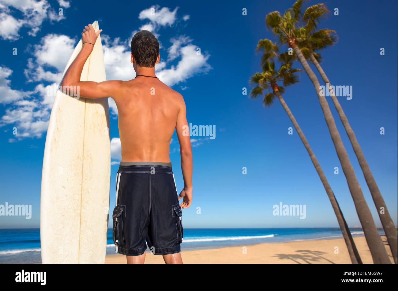 Boy surfer back view holding surfboard on beach Stock Photo - Alamy