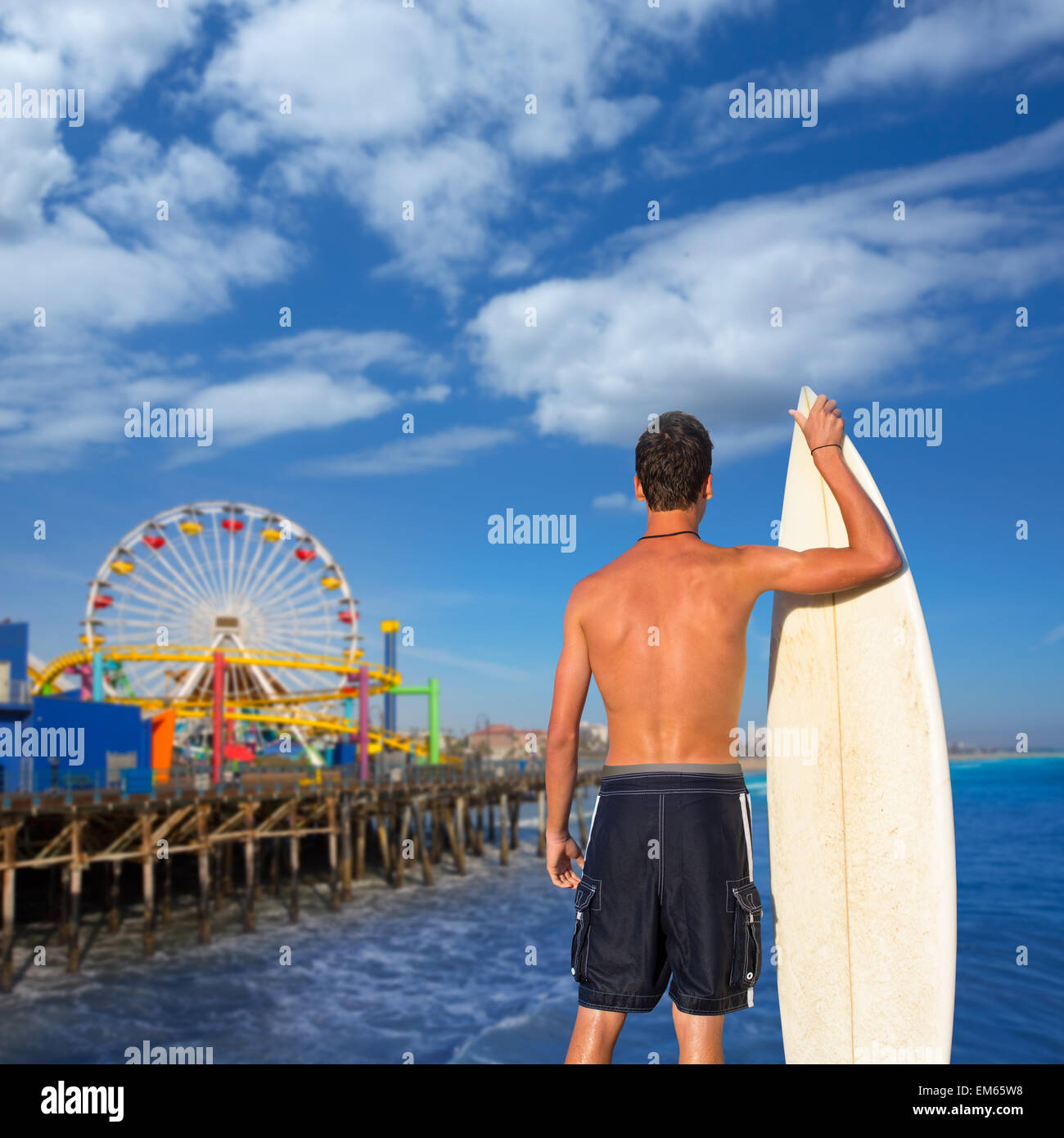 Boy surfer back view holding surfboard on beach Stock Photo - Alamy