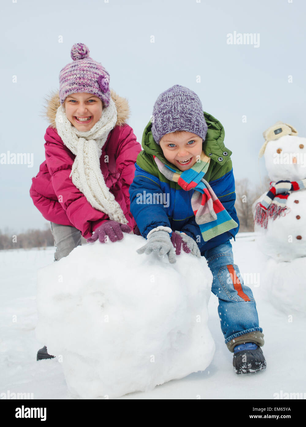 Kids make a snowman Stock Photo - Alamy