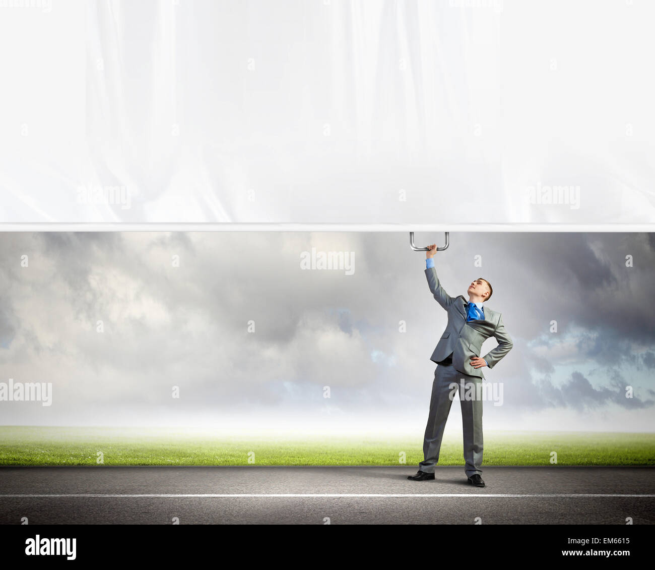 Young man pulling banner Stock Photo - Alamy