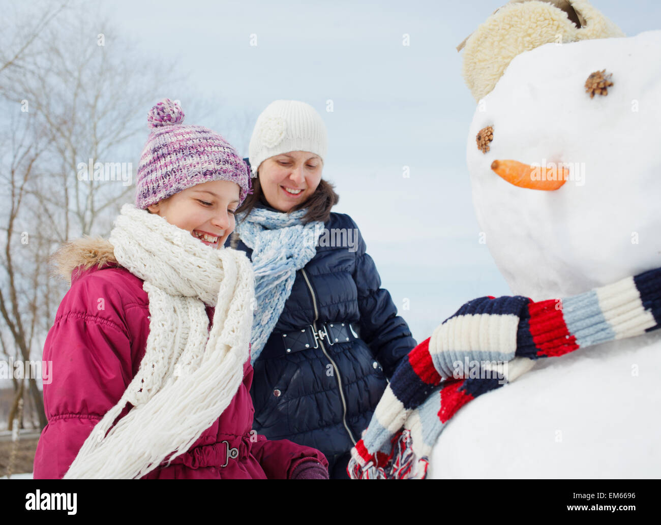 Family make a snowman Stock Photo - Alamy