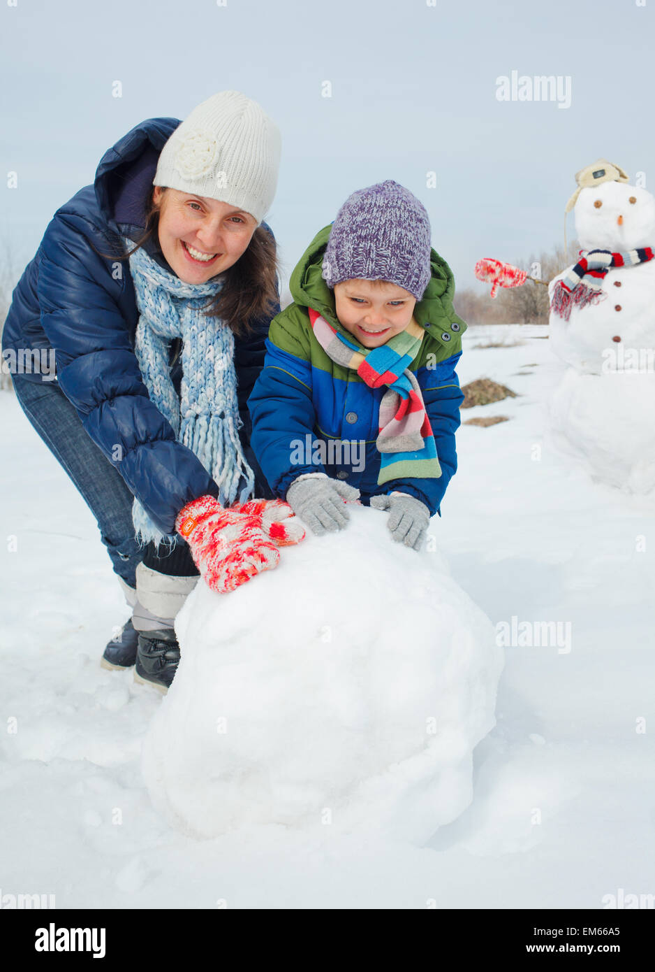 Family make a snowman Stock Photo - Alamy