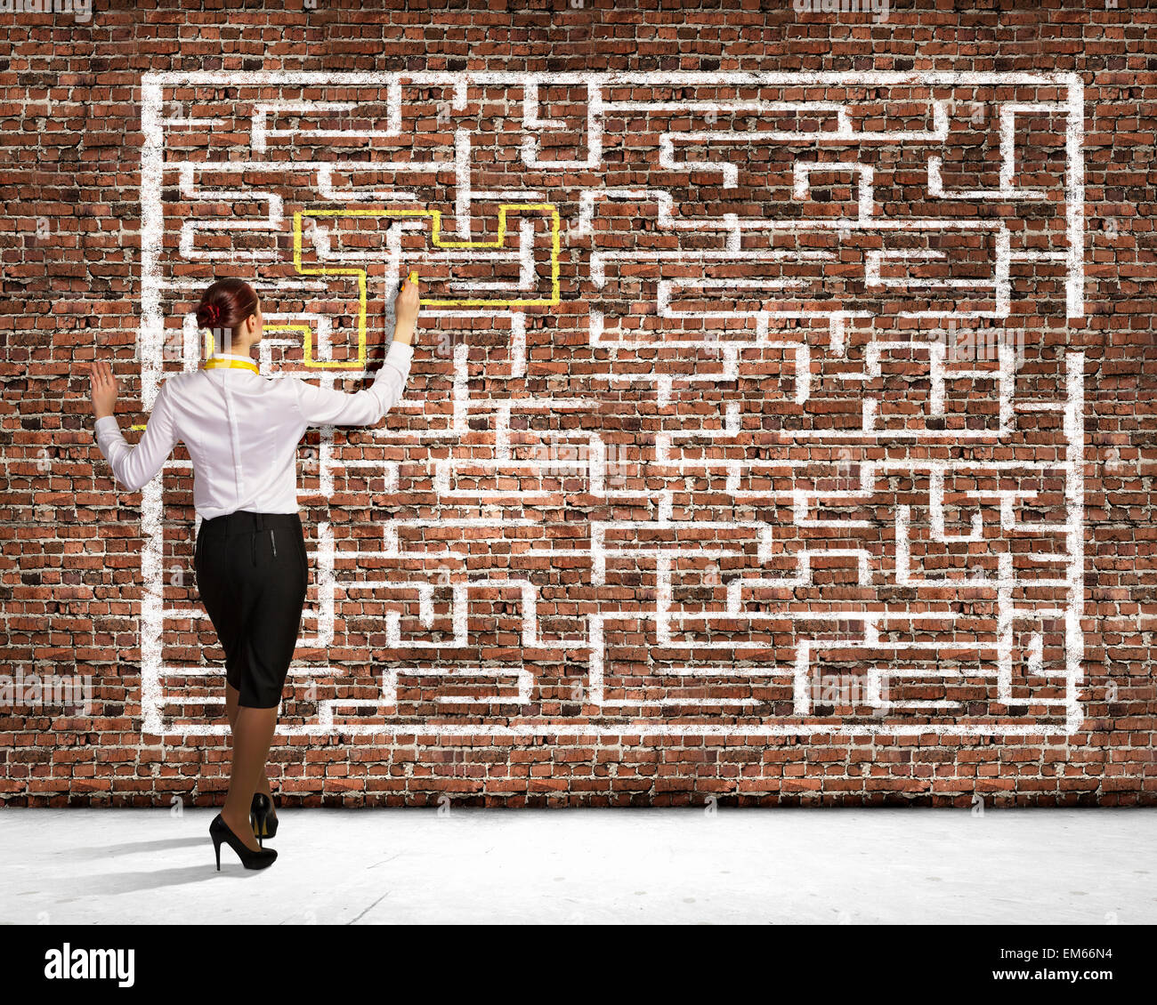 Businesswoman solving maze problem Stock Photo - Alamy