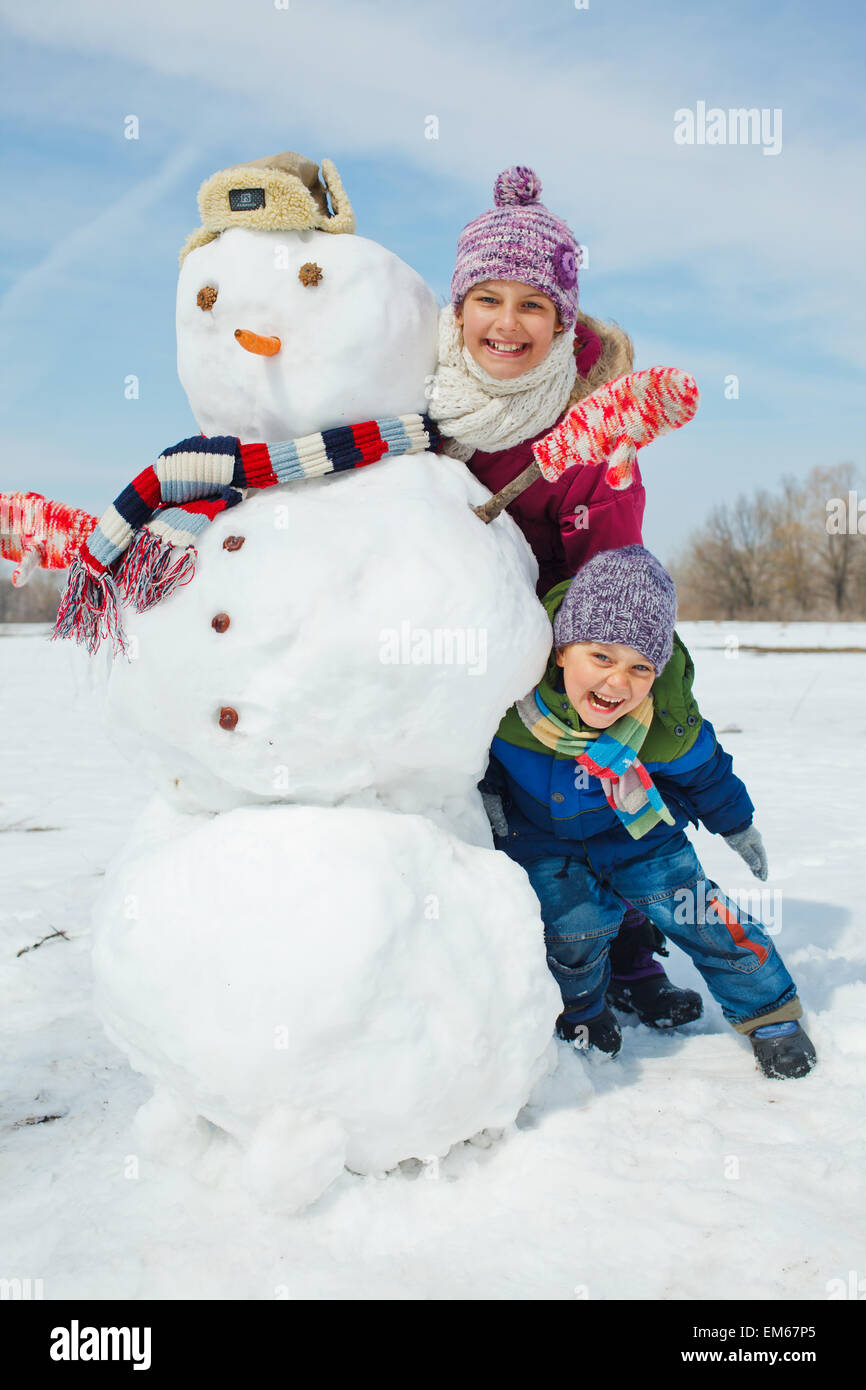 Kids make a snowman Stock Photo - Alamy