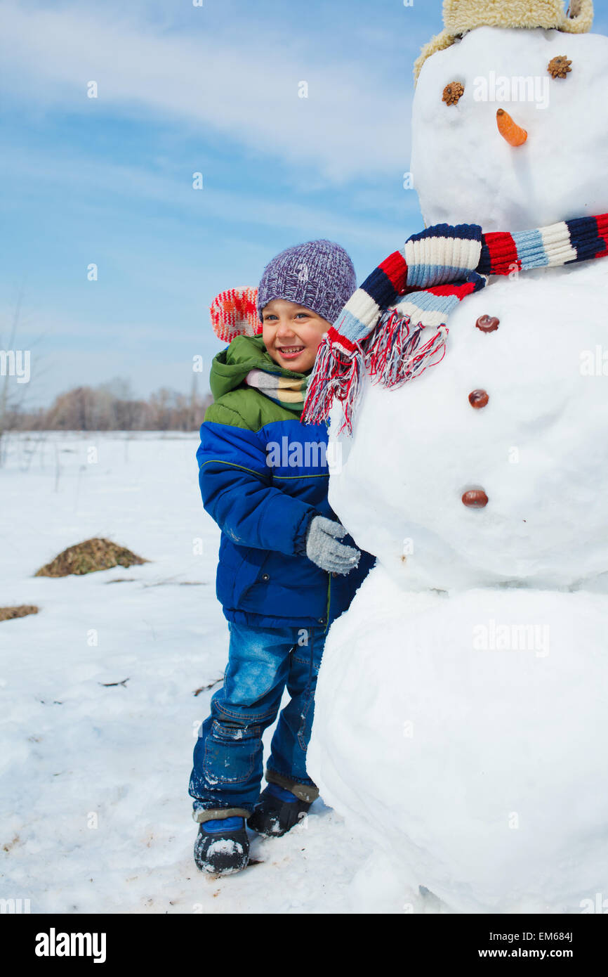 Boy makes a snowman Stock Photo - Alamy